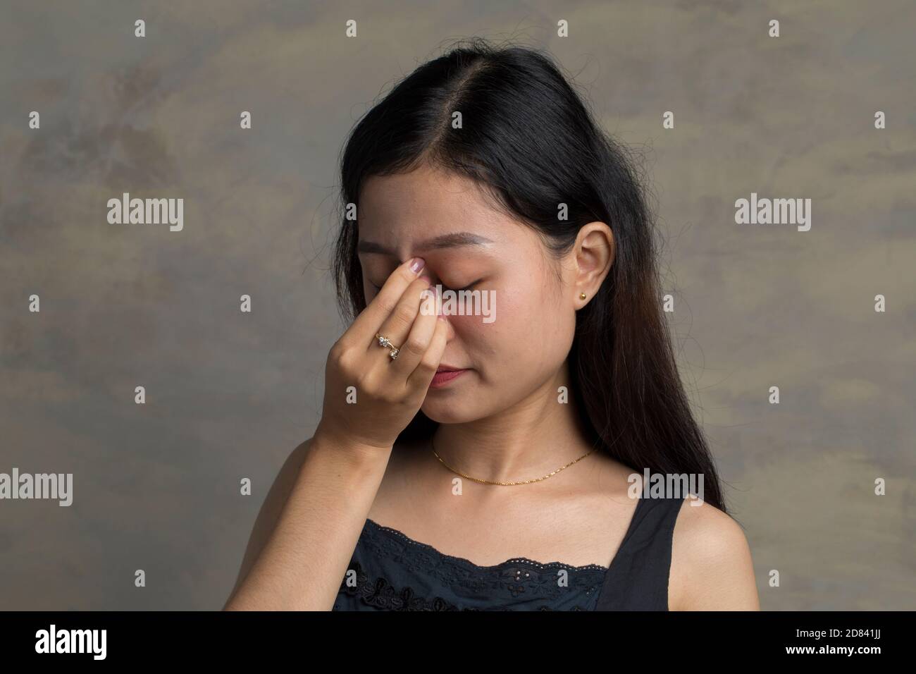 Asian Woman feeling eye pain Stock Photo - Alamy