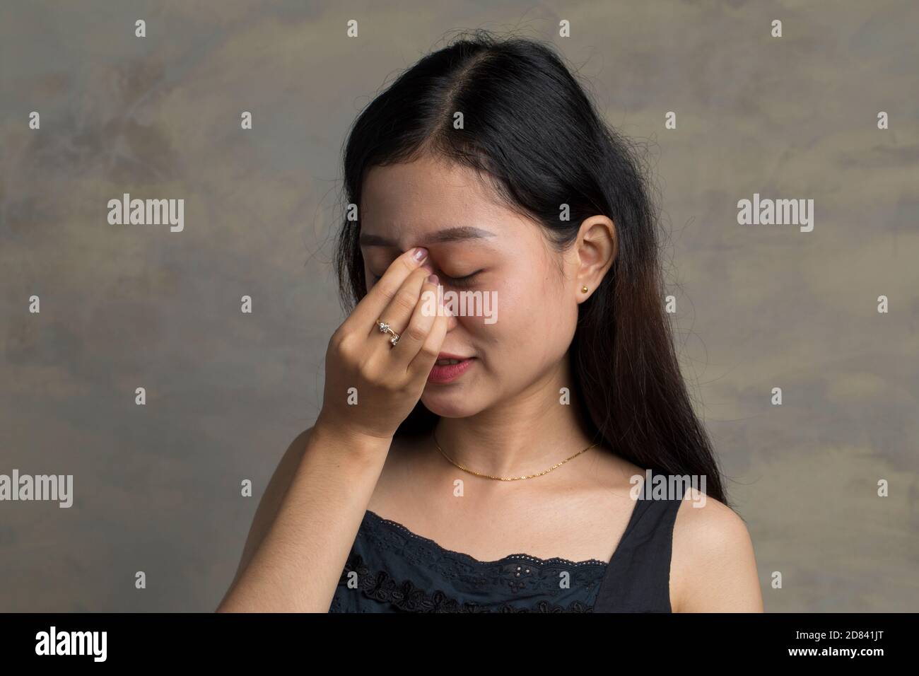Asian Woman feeling eye pain Stock Photo - Alamy