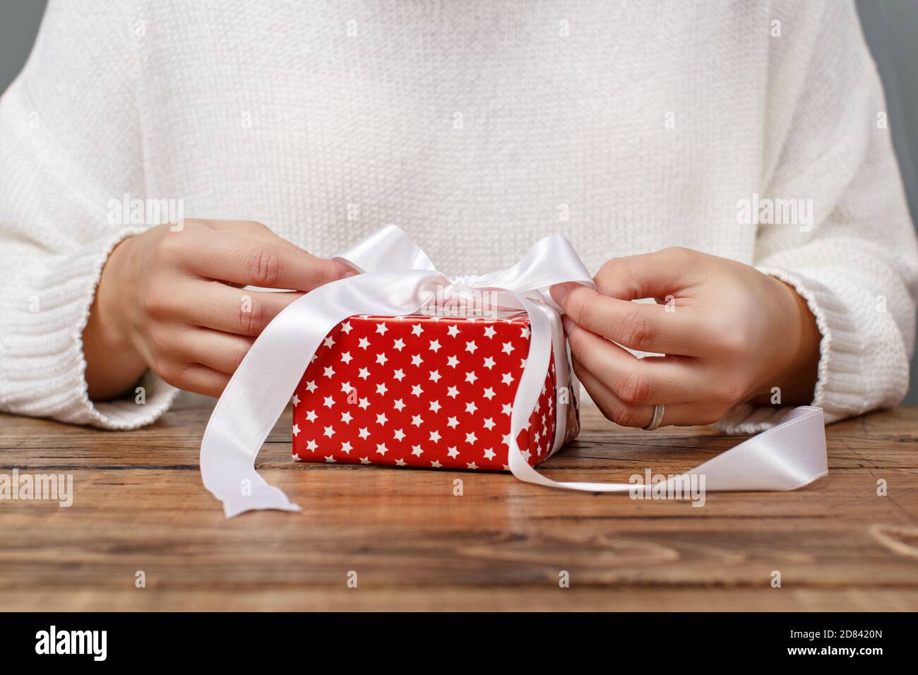 Woman ties ribbon bow on hi-res stock photography and images - Alamy