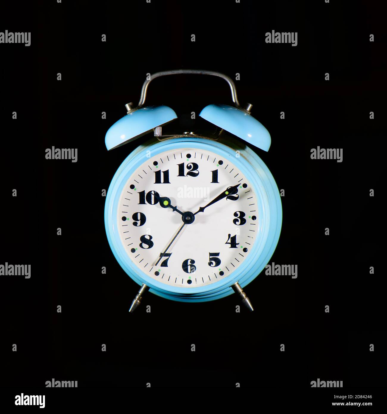 Classic table alarm clock light blue on a black background Stock Photo ...