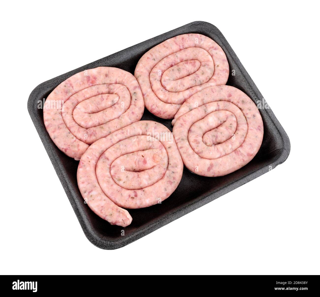 Tray of four raw Cumberland pork sausage swirls isolated on a white ...