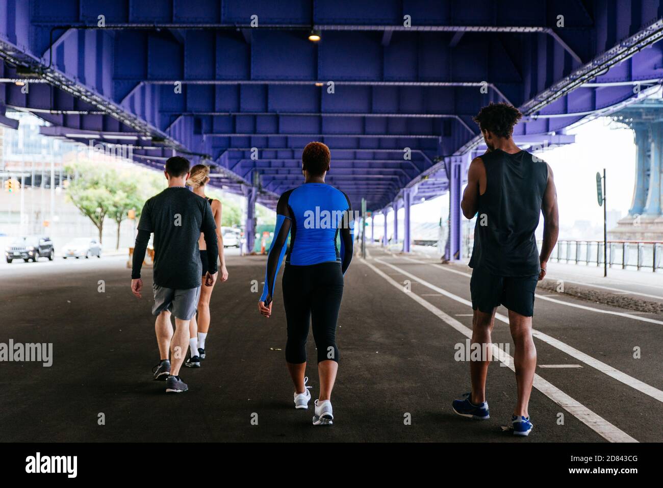 Group of urban runners running on the street in New york city ...