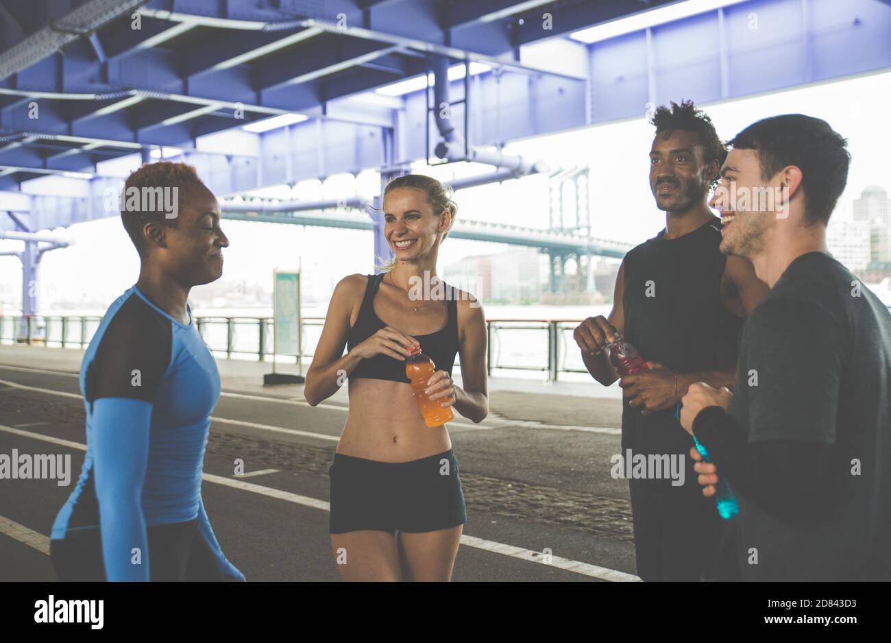 Group of urban runners running on the street in New york city ...