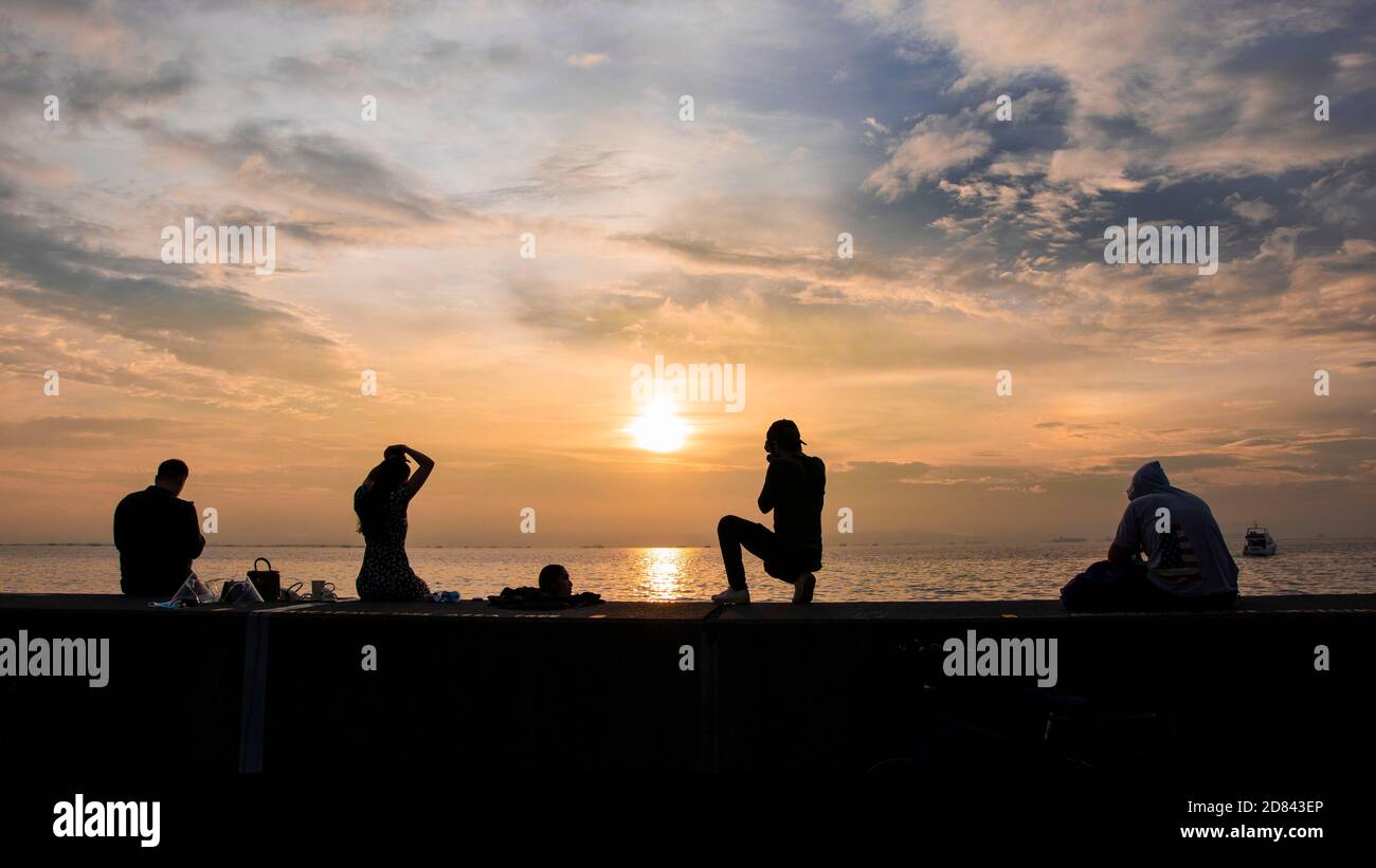 A silhouette group of young people watching sunset hi-res stock ...