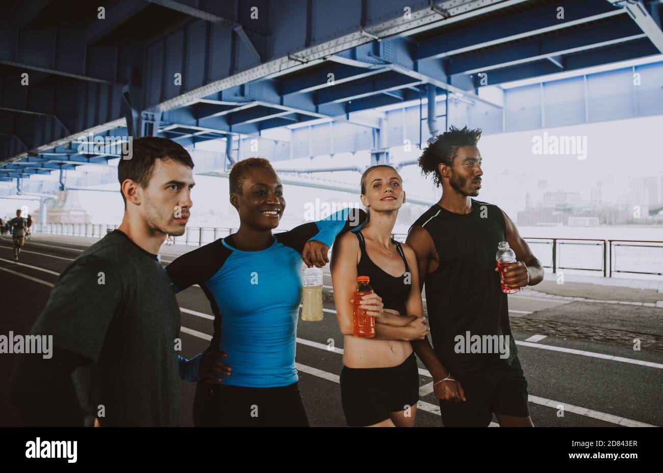 Group of urban runners running on the street in New york city ...