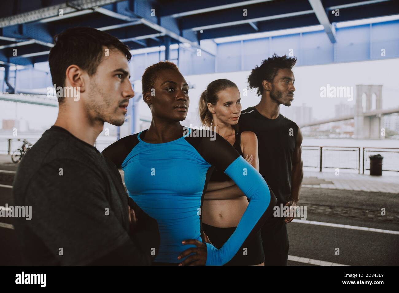 Group of urban runners running on the street in New york city ...