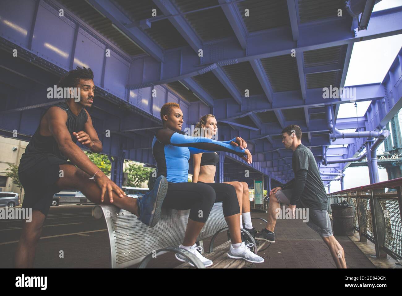 Group of urban runners running on the street in New york city ...