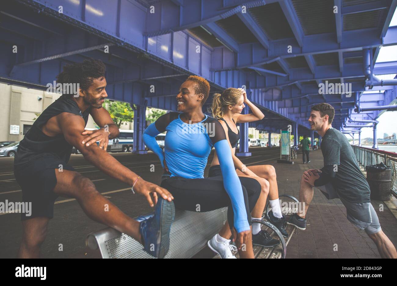 Group of urban runners running on the street in New york city ...