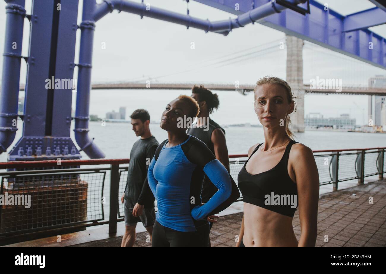 Group of urban runners running on the street in New york city ...