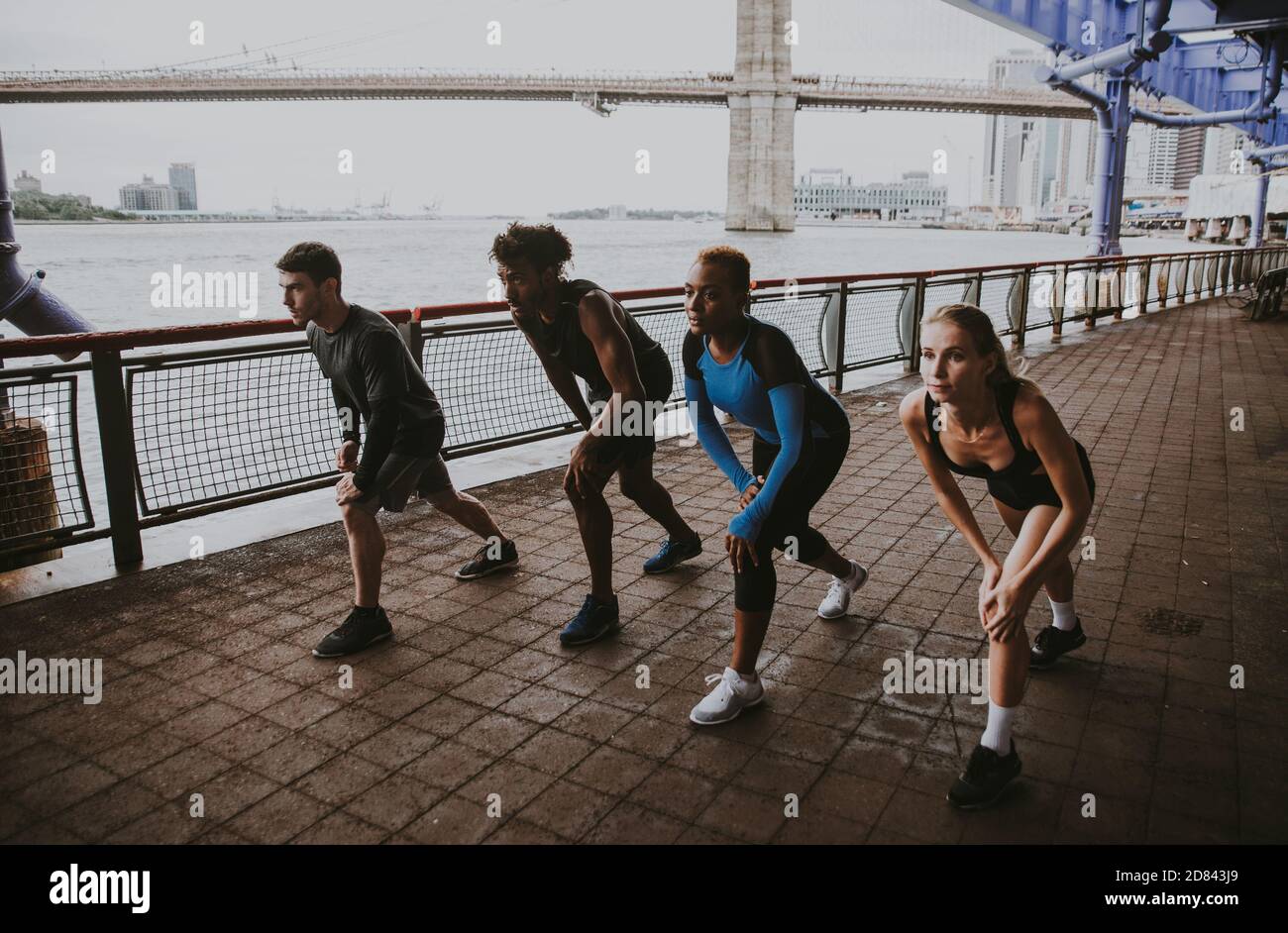 Group of urban runners running on the street in New york city ...