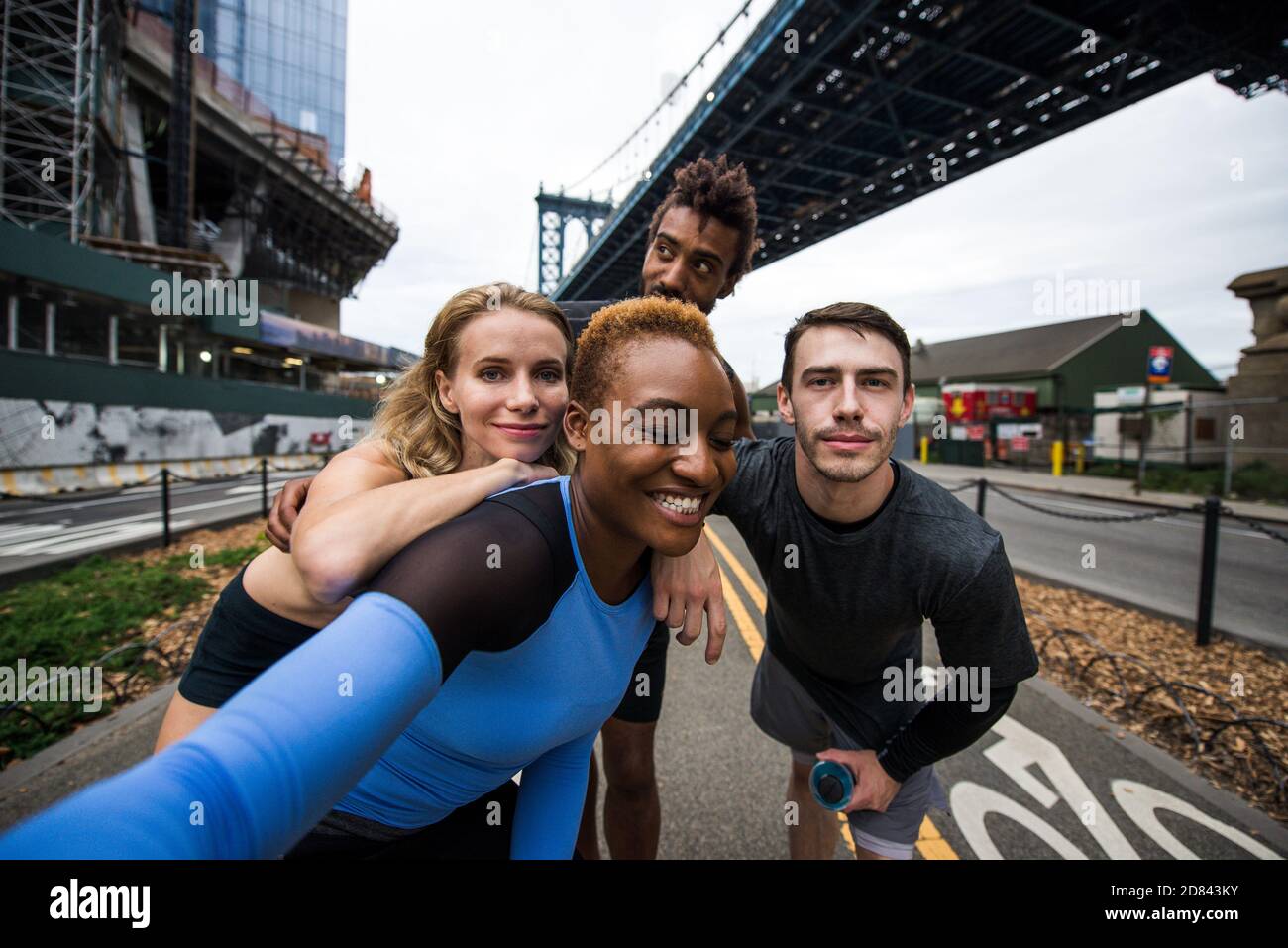 Group of urban runners running on the street in New york city ...