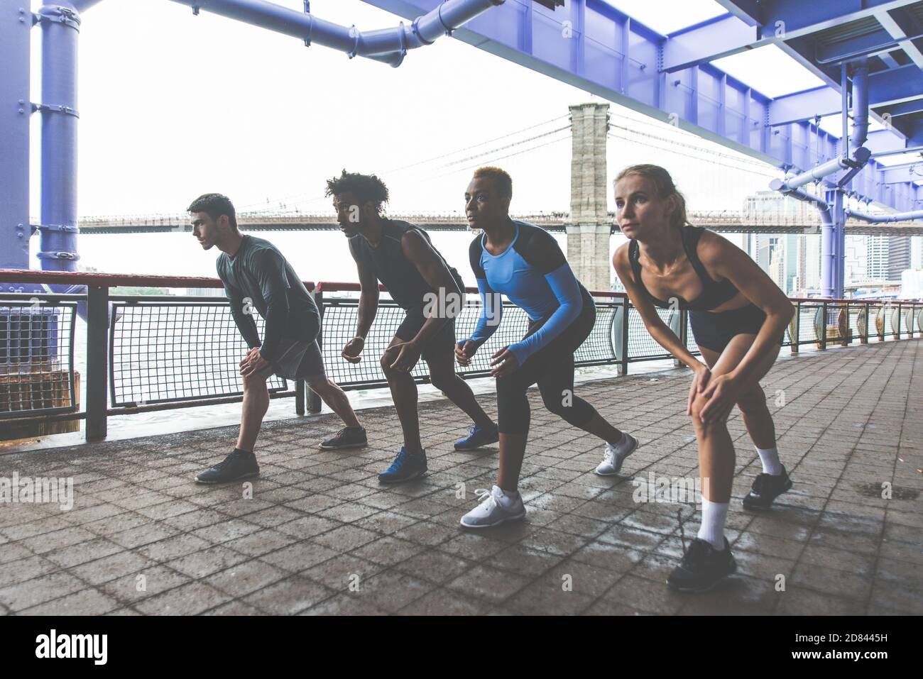 Group of urban runners running on the street in New york city ...