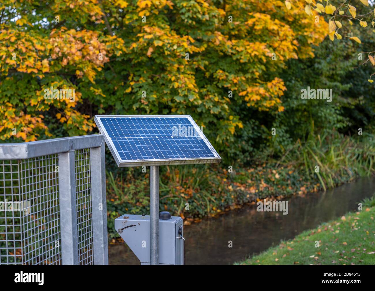 Small solar panel for charging remote equipment next to a stream with ...