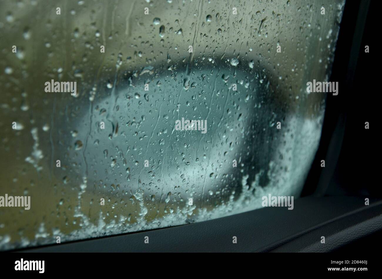 close up of fogged up car mirror looking through car window with snow ...