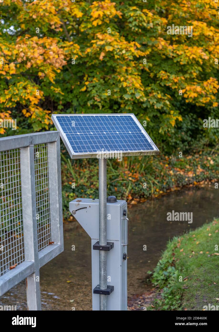 Small solar panel for charging remote equipment next to a stream with ...
