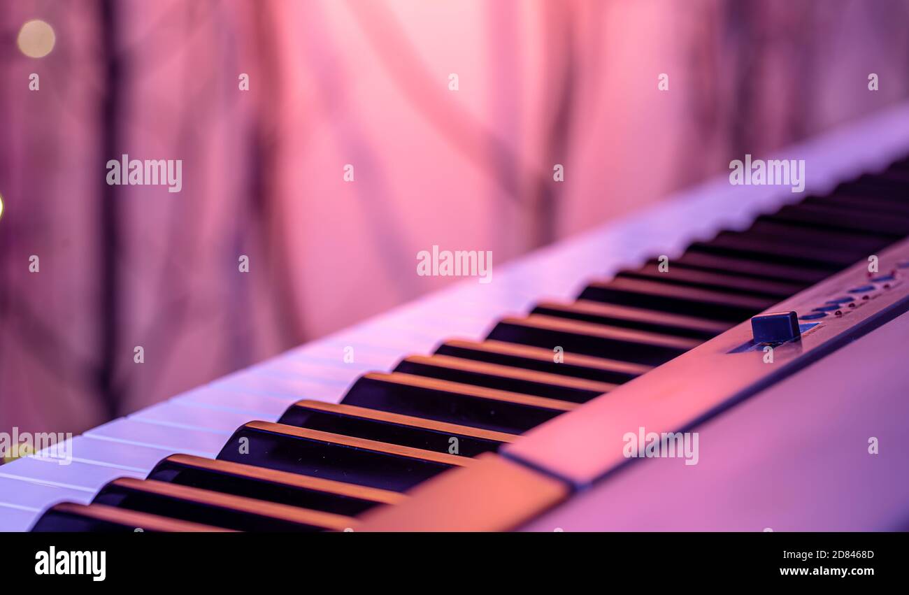 Piano keys on a beautiful colored background. Close up Stock Photo - Alamy