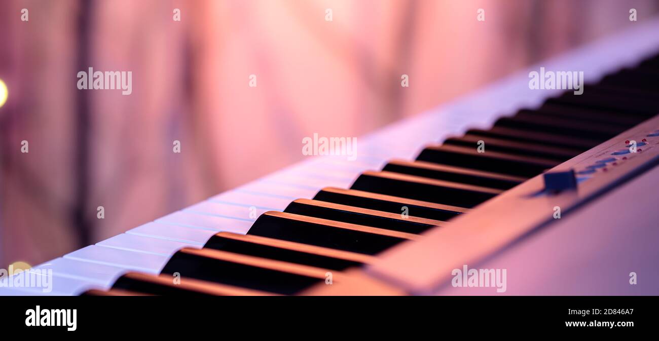 Piano keys on a beautiful colored background. Close up Stock Photo - Alamy