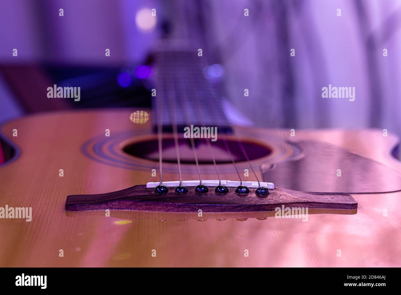 Acoustic guitar on a beautiful colored background. The concept of ...