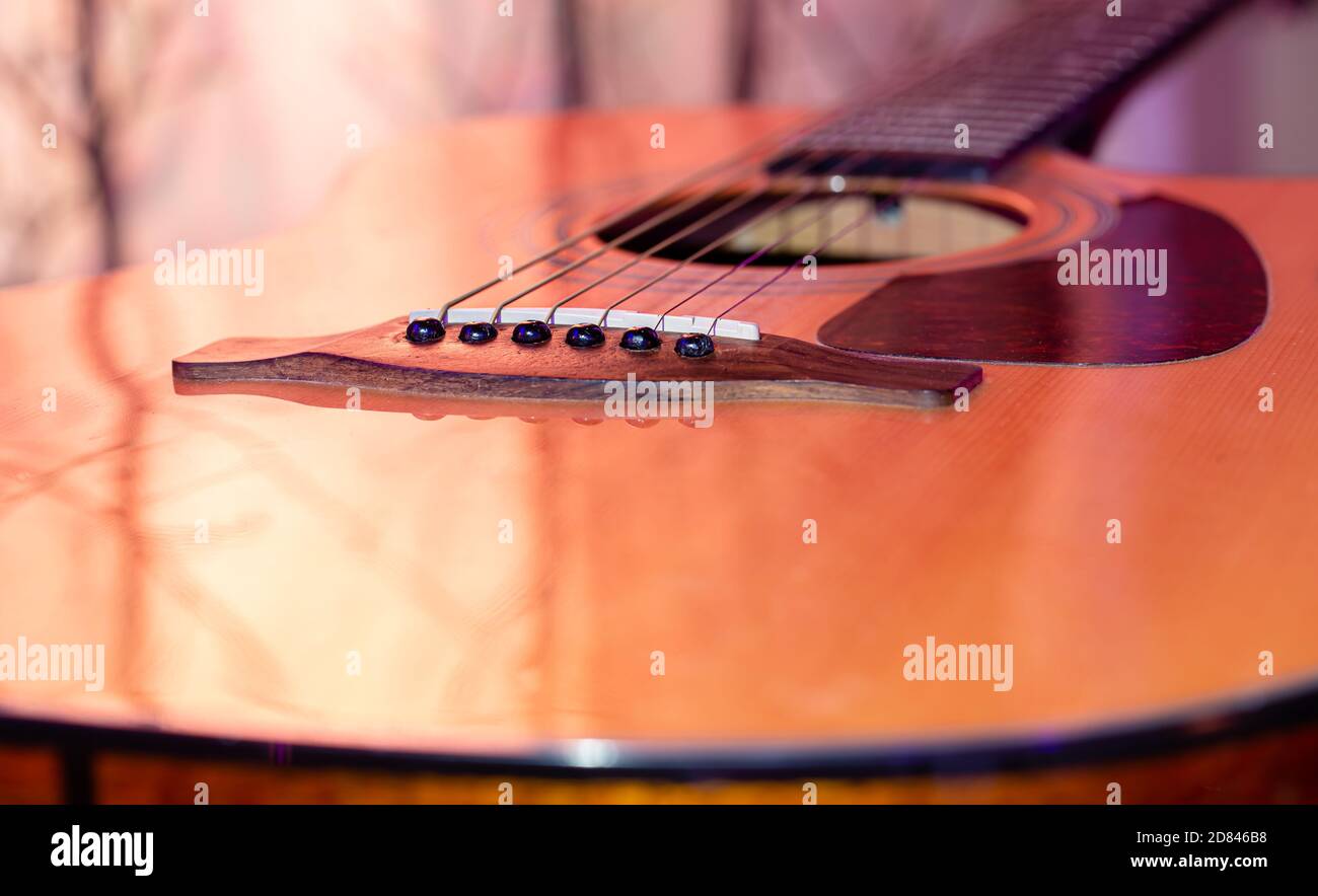 Acoustic guitar on a beautiful colored background. The concept of ...
