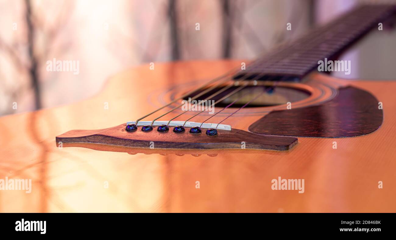 Acoustic guitar on a beautiful colored background. The concept of ...