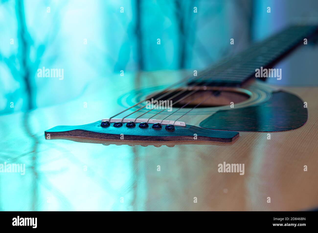 Acoustic guitar on a beautiful colored background. The concept of ...
