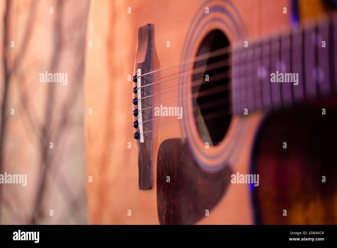 Acoustic guitar on a beautiful colored background. The concept of ...