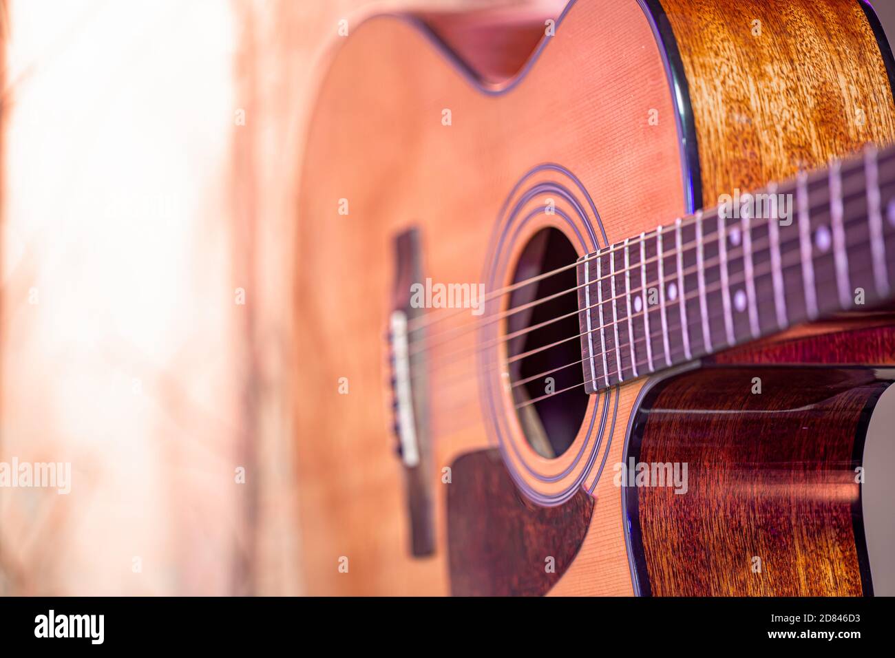 Acoustic guitar on a beautiful colored background. The concept of ...