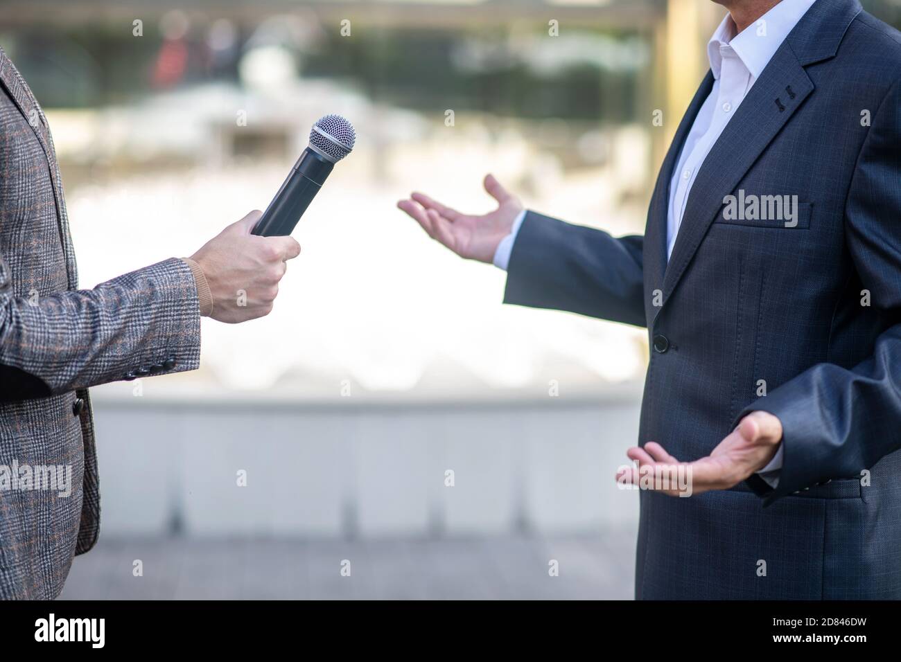 Close-up of male hands holding microphone during interview Stock Photo ...