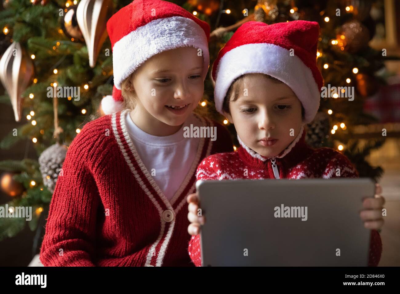 Happy children play on tablet on holidays at home Stock Photo - Alamy