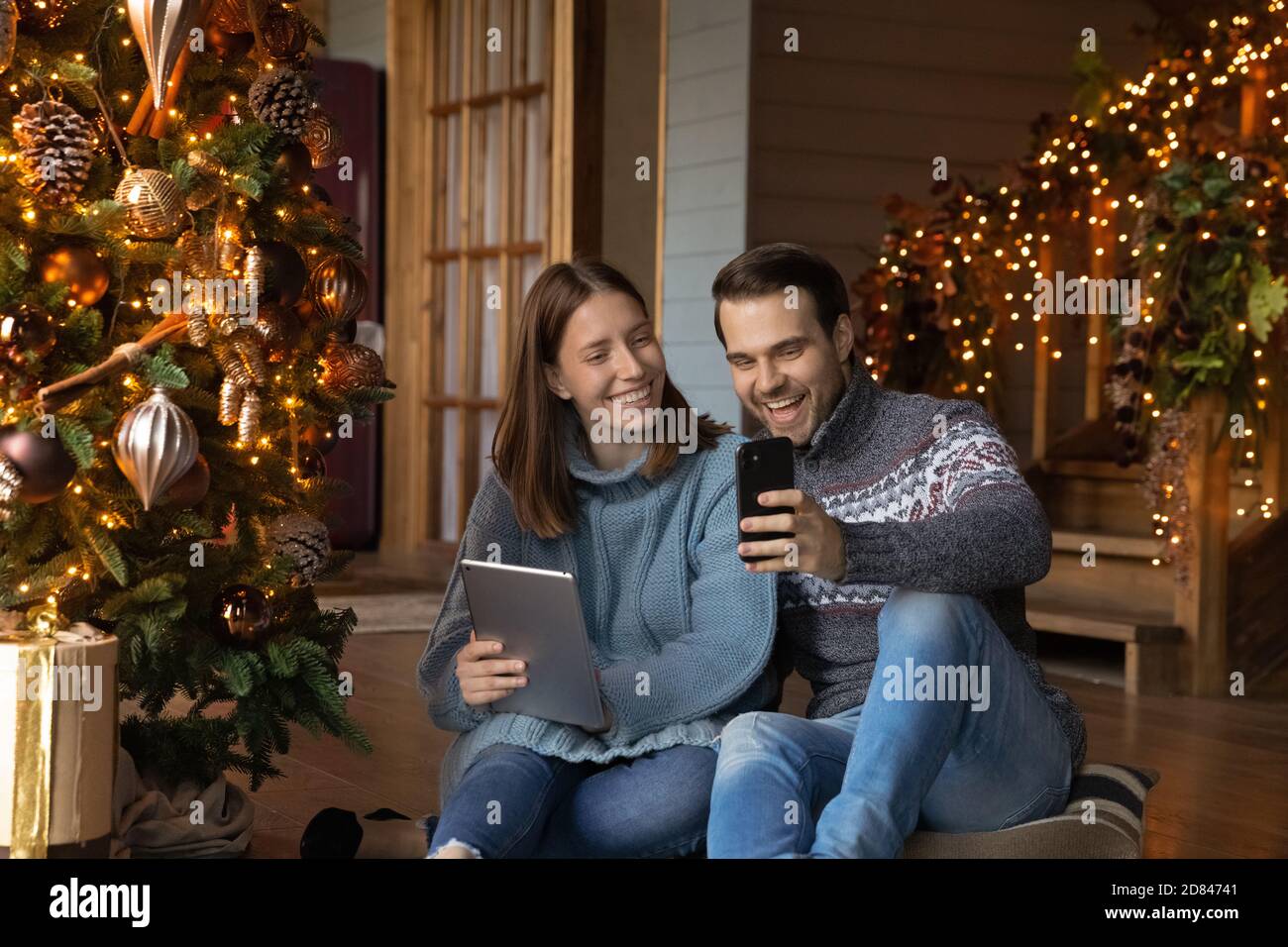Happy couple have fun using modern gadgets at home Stock Photo - Alamy