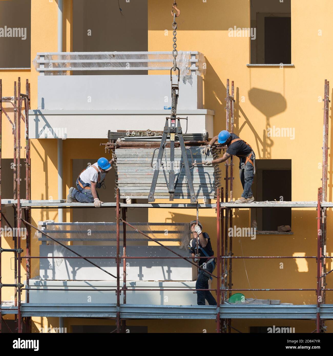 Workers at Work on a Scaffold in a Building Site for the Construction ...