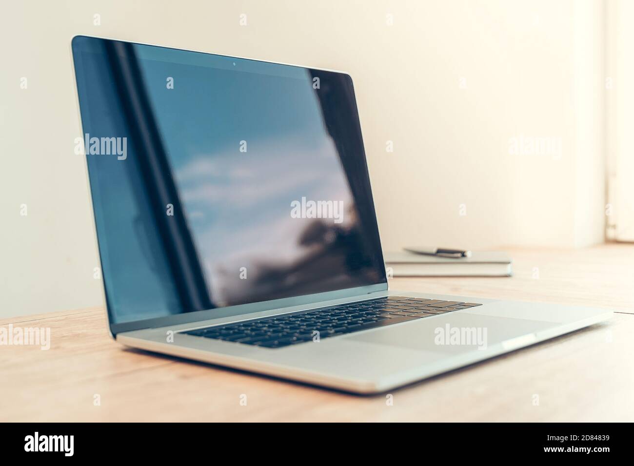 side view. open laptop on the desktop Stock Photo - Alamy