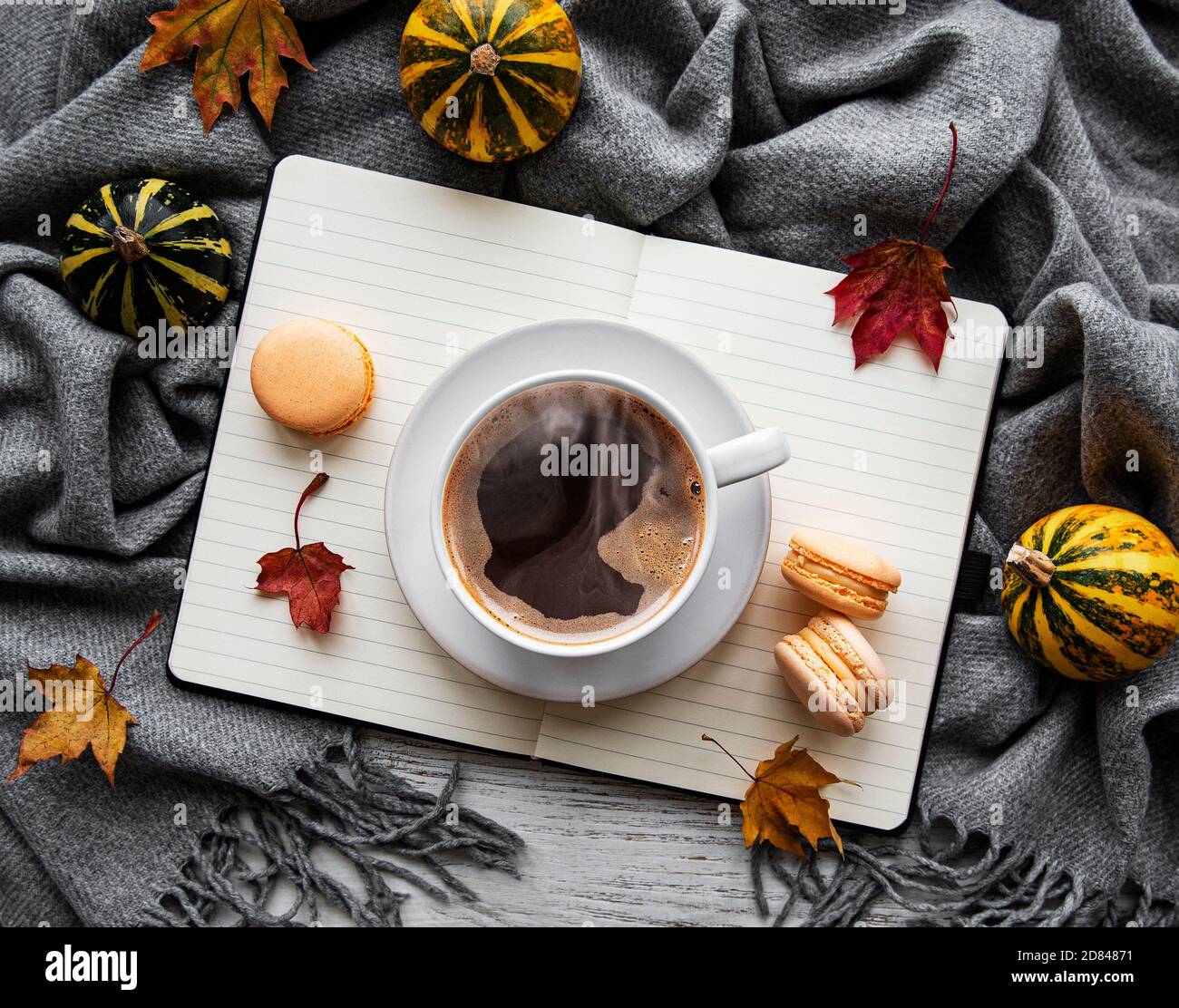 Maple leaves, notebook, coffee cup and scarf. Autumn or Winter concept ...