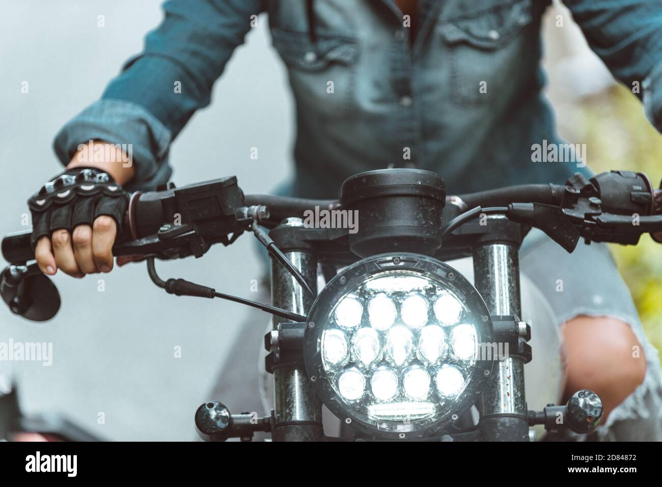Beautiful girl having fun driving her custom cafe racer motorcycle ...