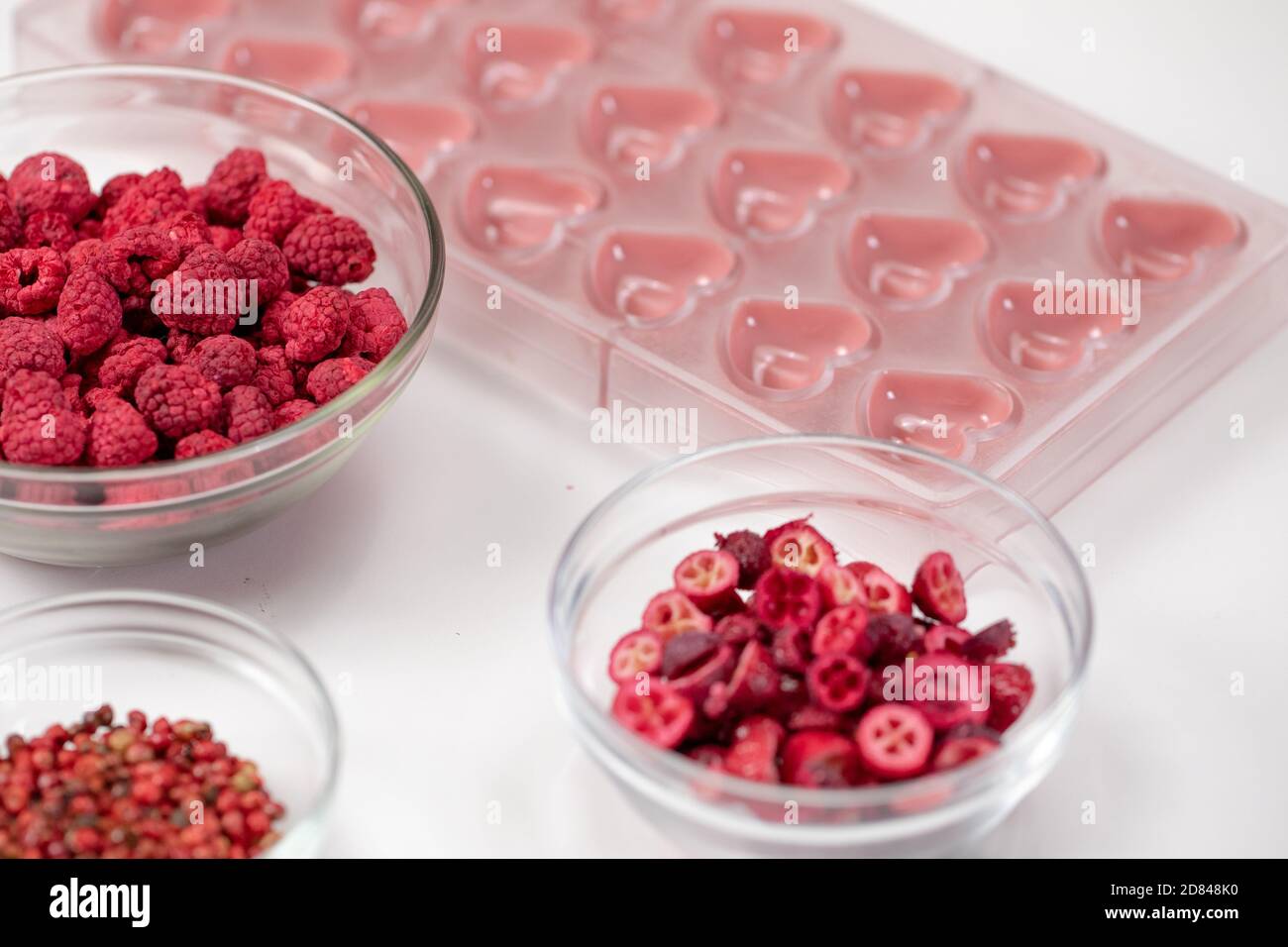 Heart shape confectionery mold with ruby chocolate and dried red ...