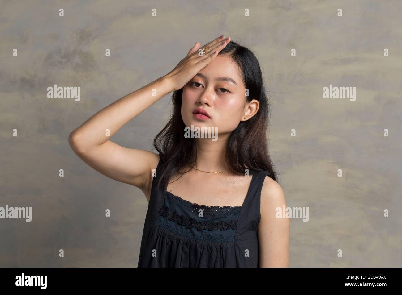 Sad tired young asian woman touching forehead having headache migraine ...