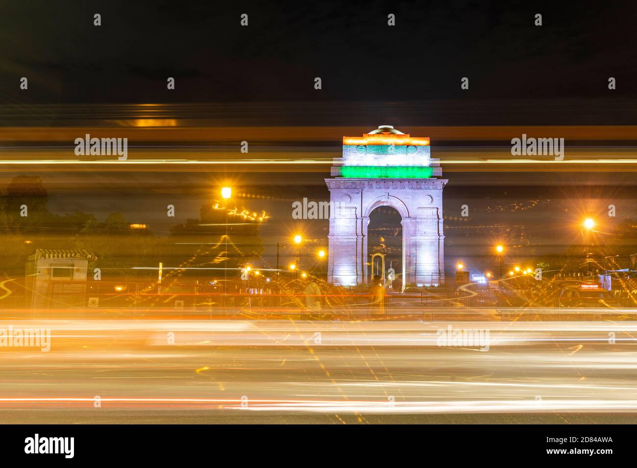 View of vehicle light trails at night infront of the iconic India Gate ...