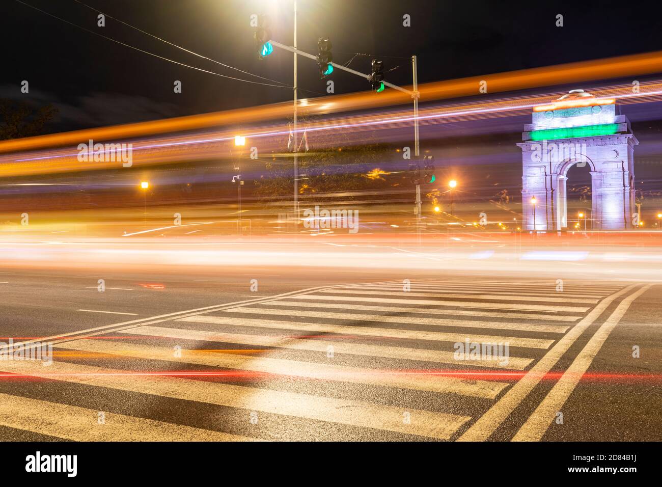 View of vehicle light trails at night infront of the iconic India Gate ...