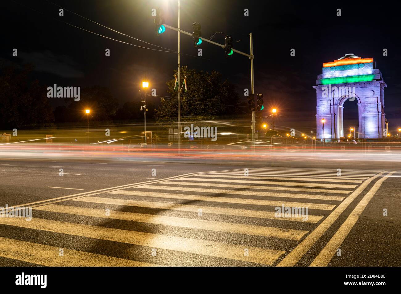 View of vehicle light trails at night infront of the iconic India Gate ...