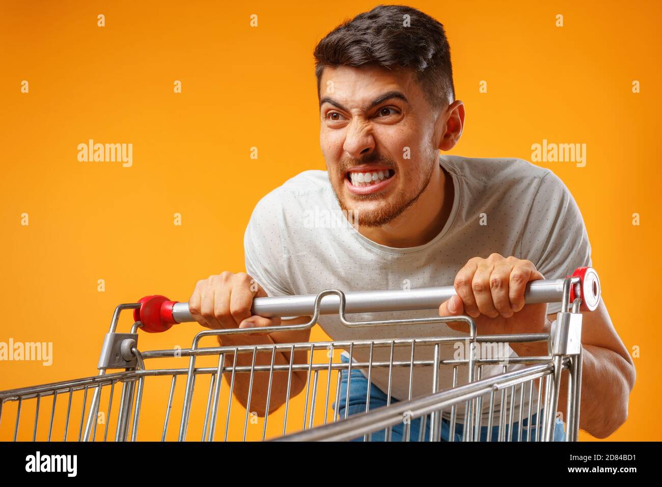 Funny crazy man rushing with shopping trolley to sale Stock Photo - Alamy