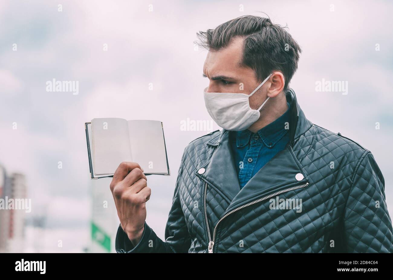 guy in a protective mask showing his open passport Stock Photo - Alamy