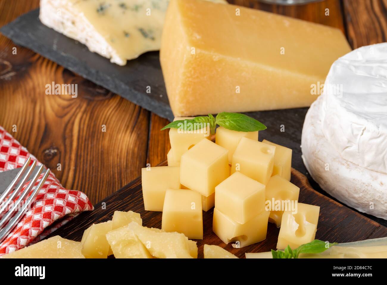 Cut pieces of hard cheese close up Stock Photo - Alamy