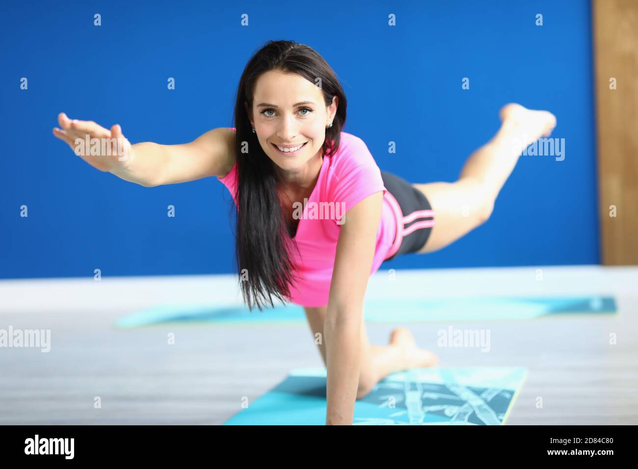 Woman goes in for sports doing body balancing exercises Stock Photo - Alamy