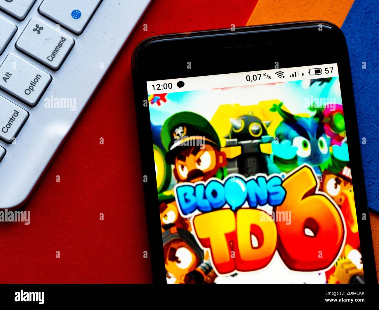 In this photo illustration a Bloons TD 6. appliance by Ninja Kiwi. logo ...