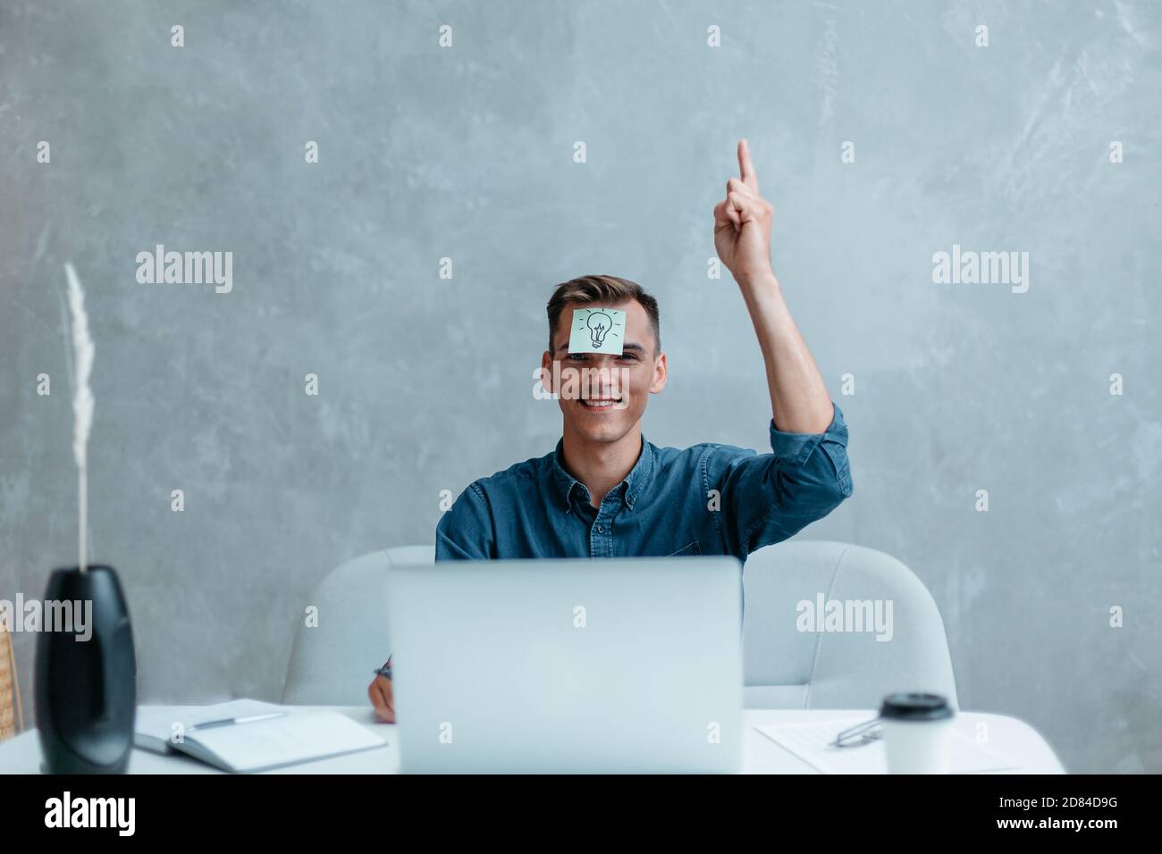 Satisfied man with raised hand thinking about good creative idea Stock ...