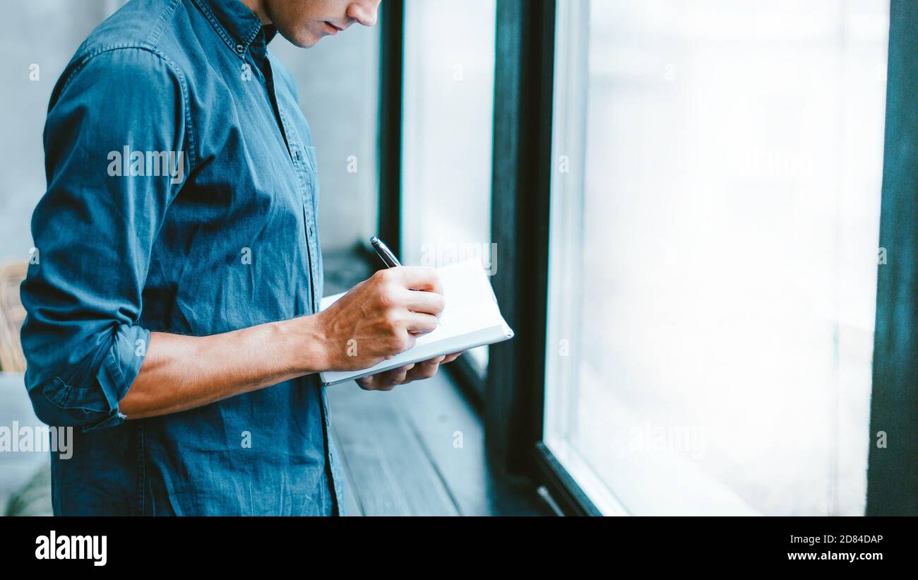 Businessman standing window looking distance hi-res stock photography ...