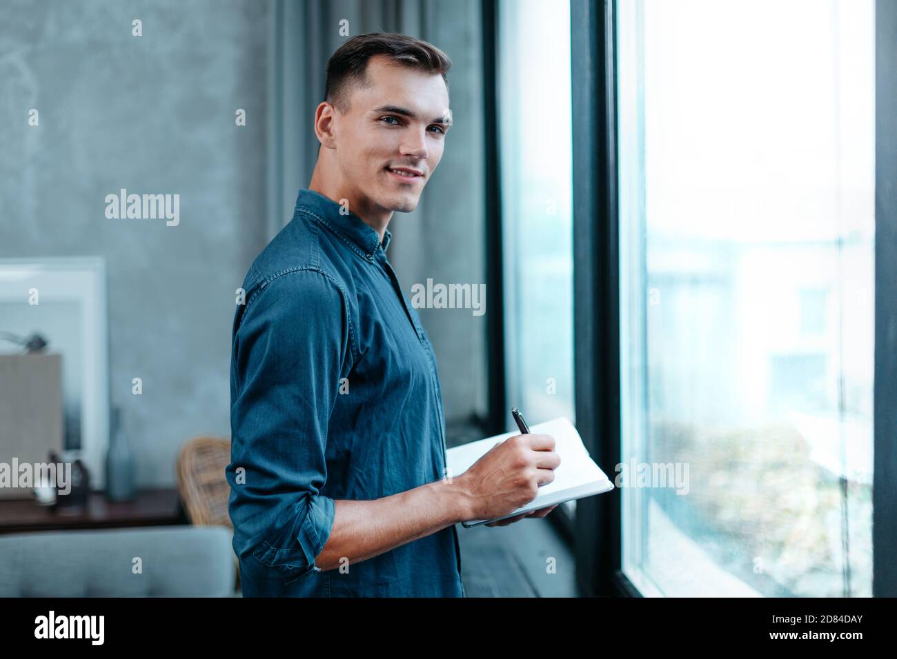 Businessman standing window looking distance hi-res stock photography ...