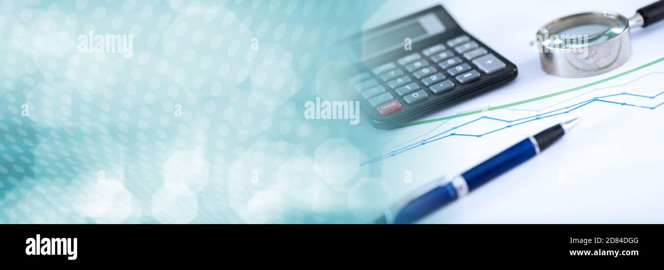 Magnifying glass, calculator, pen on a financial graph; panoramic ...