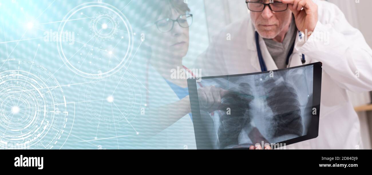 Two doctors examining x-ray report in medical office; multiple exposure ...