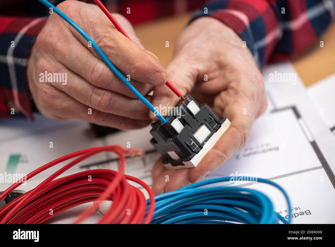 Electrician hands connecting a wire into a power socket Stock Photo - Alamy